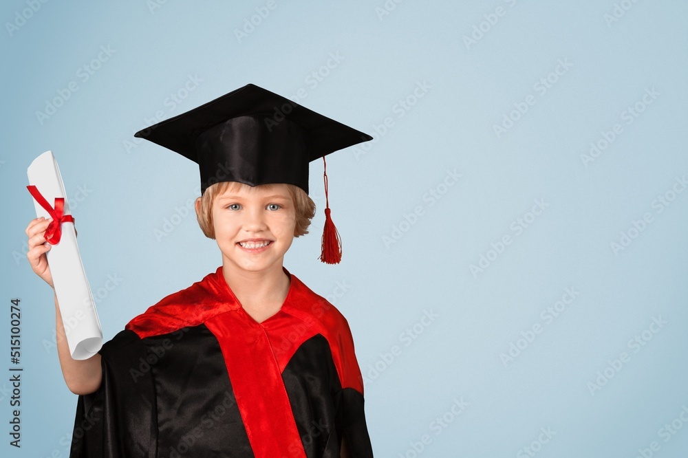 Cute kid wearing graduation cap and ceremony robe with certificate ...