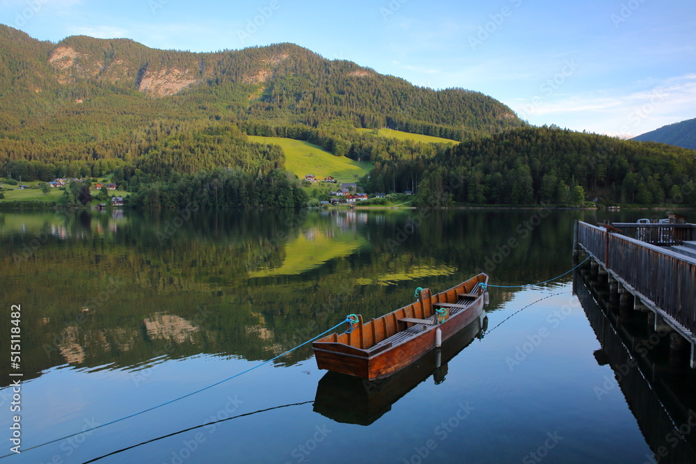 Reflections on Grundlsee lake (Western part) and green scenery ...