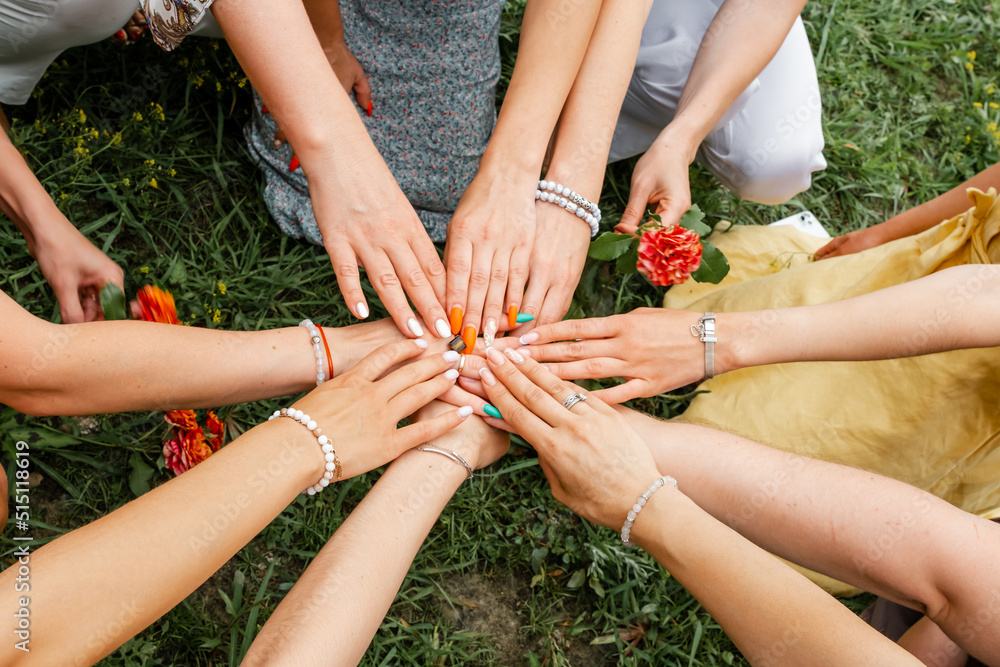 Group of people stacking hands together. Female models joining hands in ...