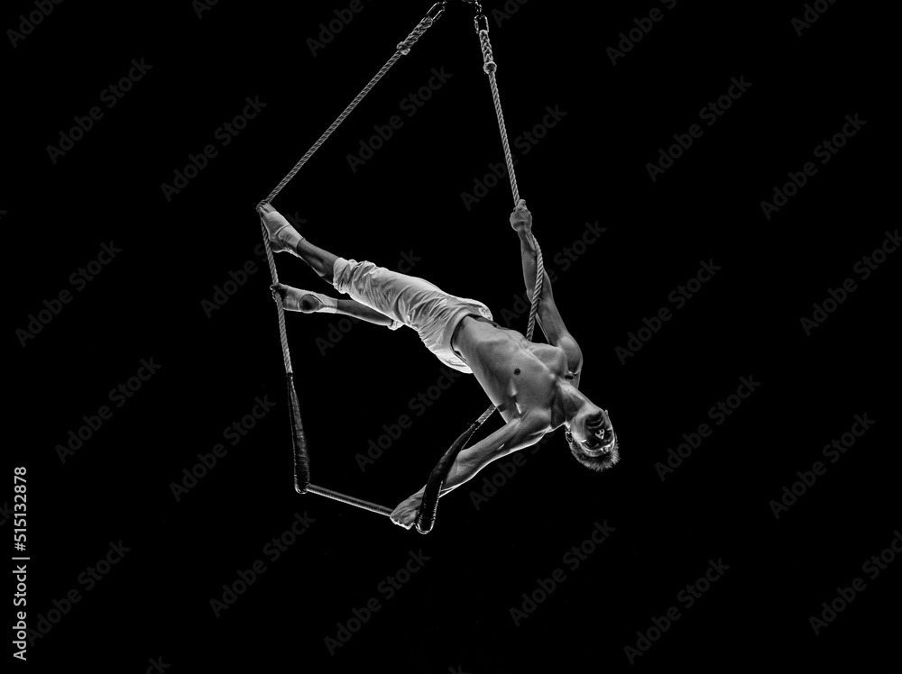Muscular male air circus artist performances with dance trapeze Stock ...