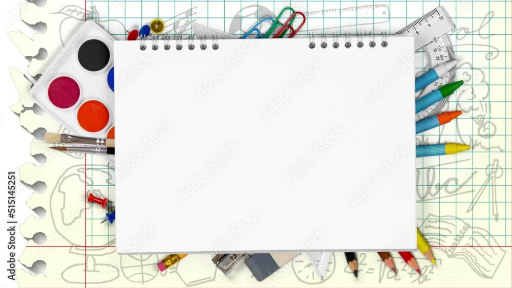 Colorful school supplies appearing underneath the blank notepad ...