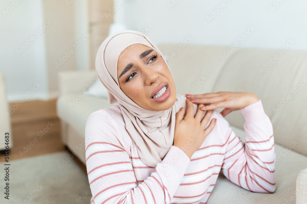 Pain in the shoulder. Upper arm pain, Arabic muslim woman with body ...