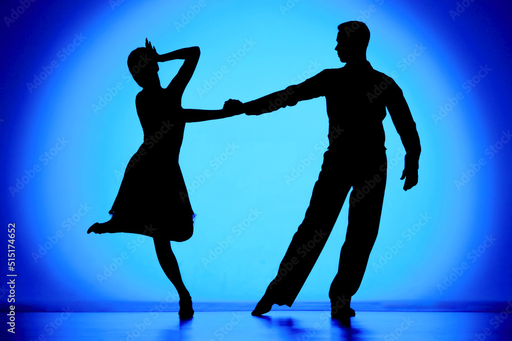 Black silhouettes of dance partners performing Argentine tango. Man and ...