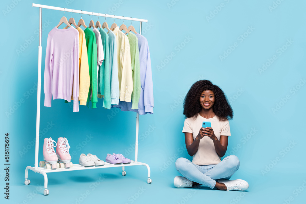 Full size photo of cheerful nice person sit floor hold telephone ...