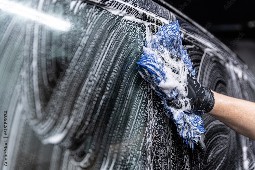 Car Wash Employee Thoroughly Washes A Modern Car With A Dedicated