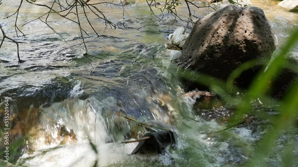 Video Stock a mountain river with a fast flow of water is polluted with ...