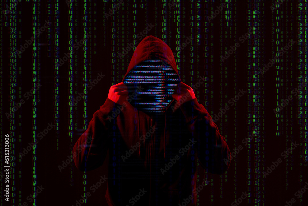 Silhouette of anonymous hacker and digital binary code on dark ...