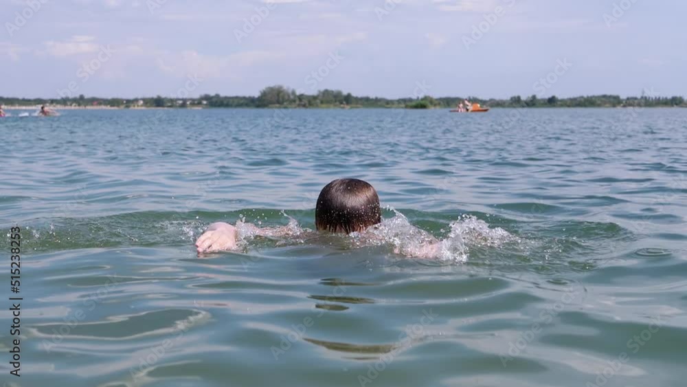 A Child Swimming, Drowning, Splashing Hands, Diving Under Water on the ...