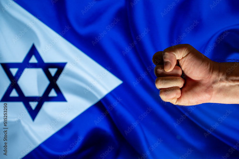 Male hand clenched into fist against blue flag background. Israeli Navy ...