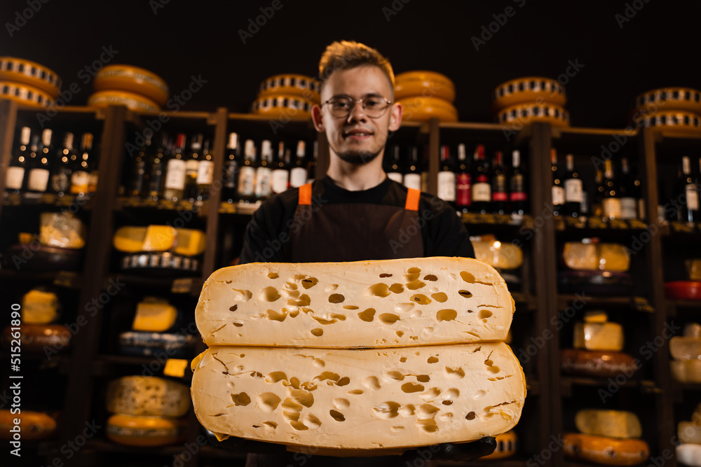 Handsome cheese sommelier with 2 half of yellow cheese wheel limited ...
