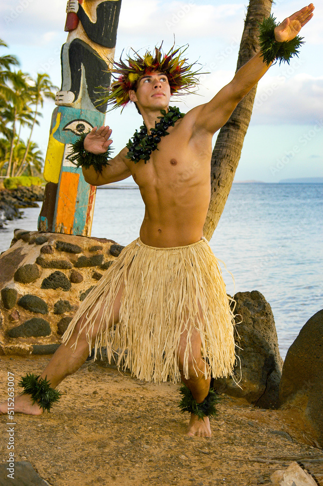 Male Hula Dance performs war dance in front of Hawaiian Totem and the ...