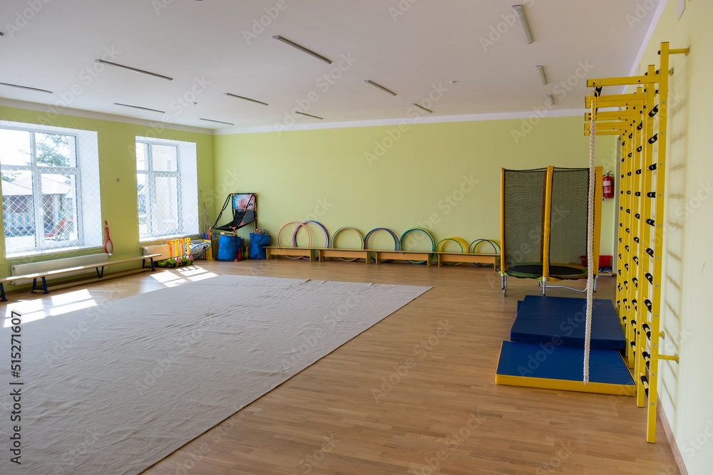 Lardge empty elementary school or kindergarten modern gym room with ...