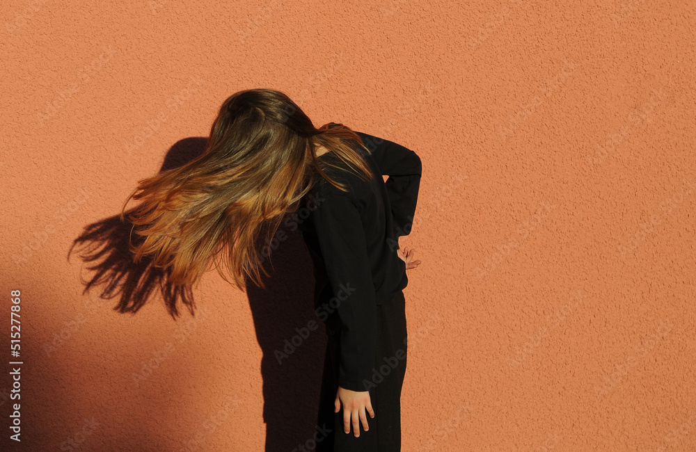 Cute little girl playing in shadow theater, making crocodile on orange ...