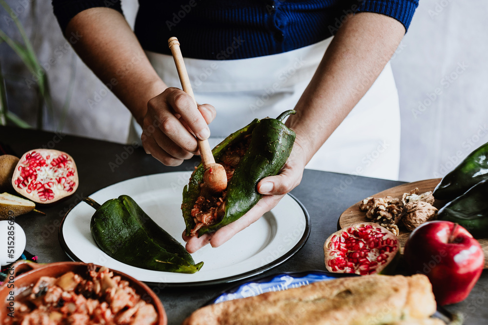 mexican woman hands preparing and cooking chiles en nogada recipe with ...