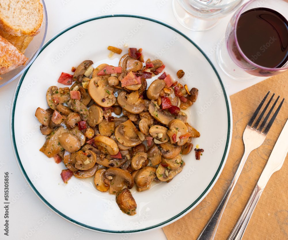 Spanish champinones salteados, roasted champignons with glass of wine ...