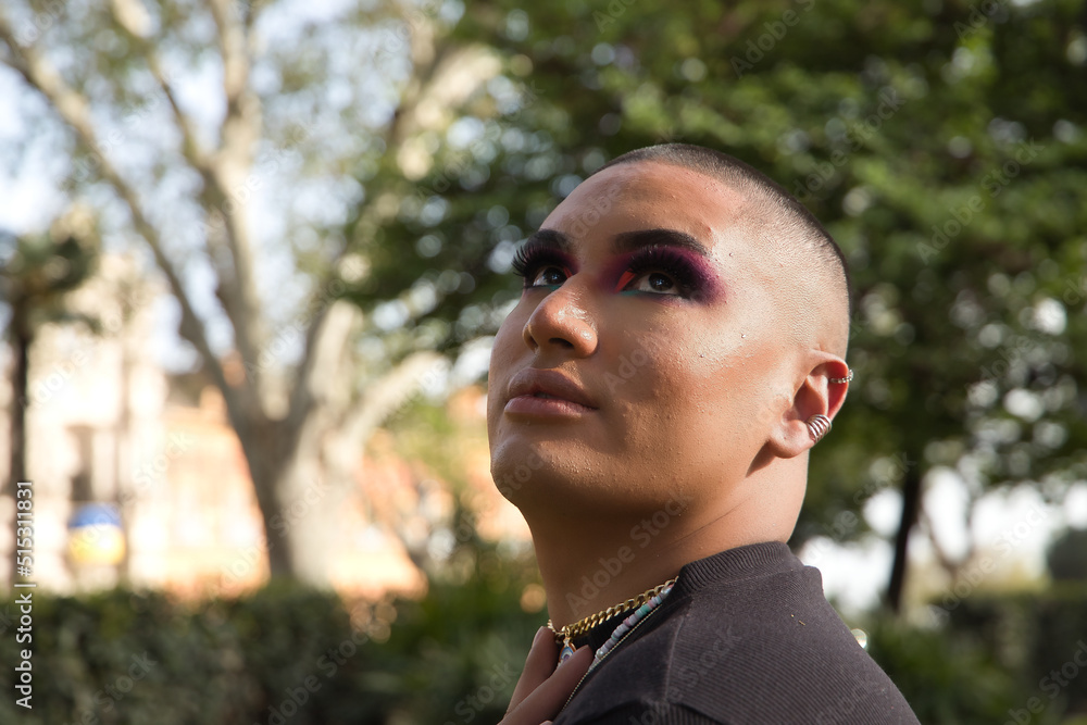 Portrait of non-binary person, young and South American, heavily make ...