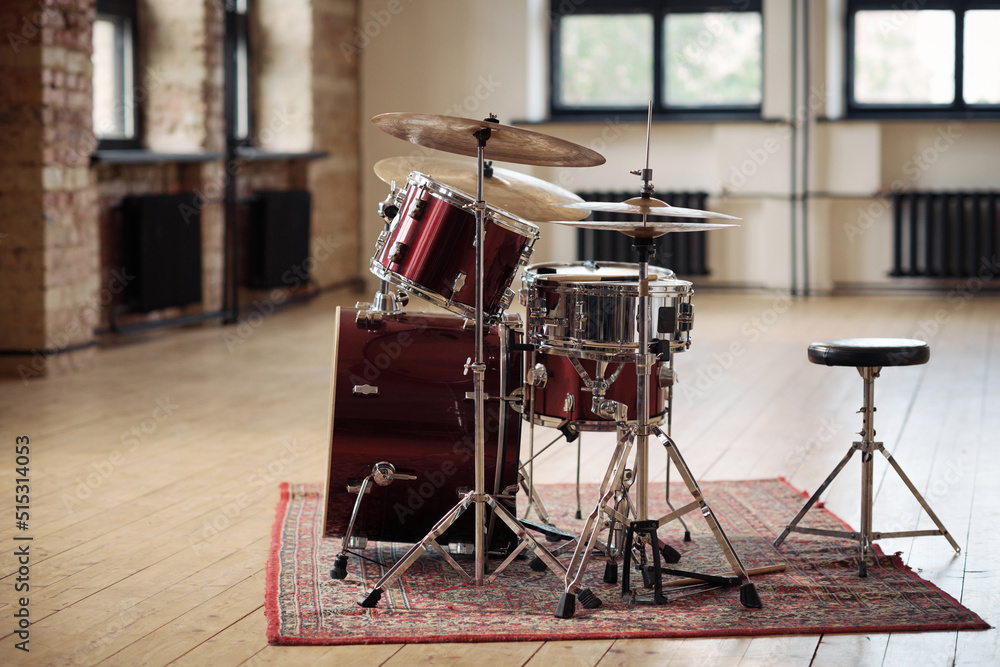 Horizontal image of drum kit for drummer standing on carpet at big ...