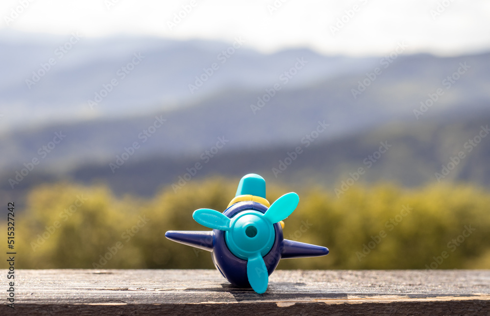 little airplane plastic toy with propeller in front on wooden board ...