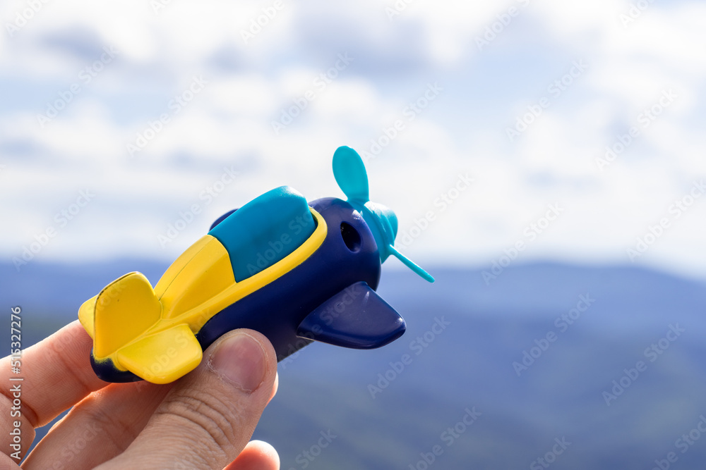 little airplane plastic toy with propeller in front on wooden board ...