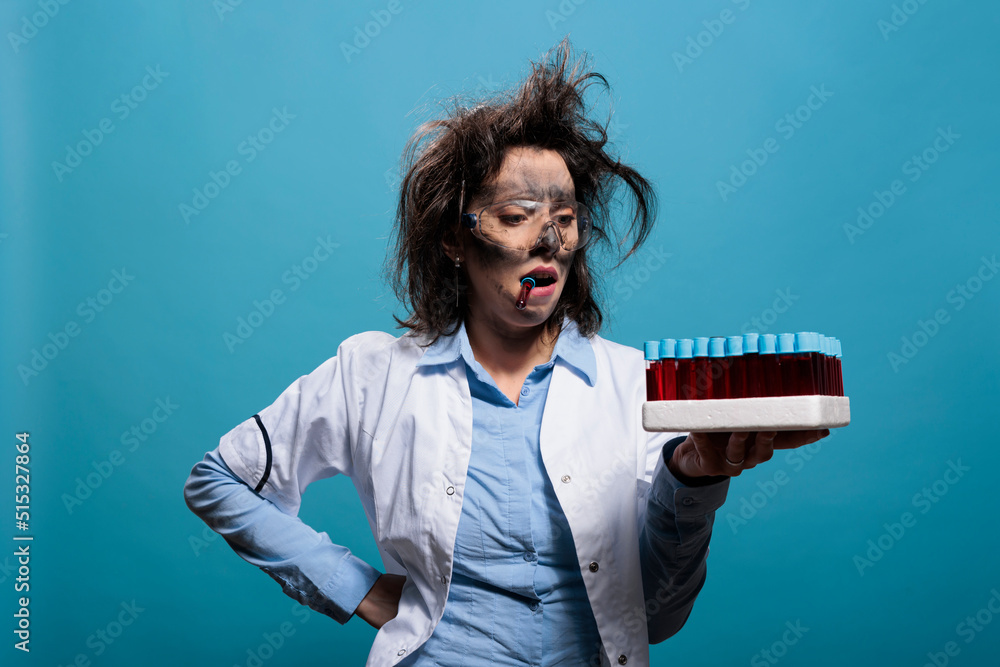 Mad biochemistry specialist with dirty face and messy hairstyle holding ...