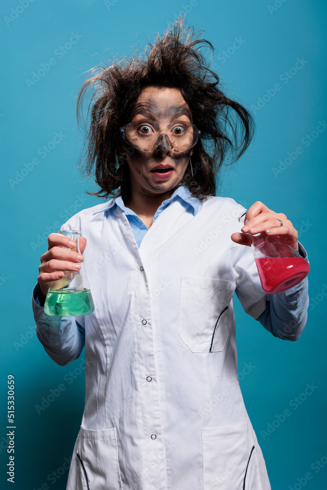 Surprised crazy chemistry specialist holding glass beakers filled with ...