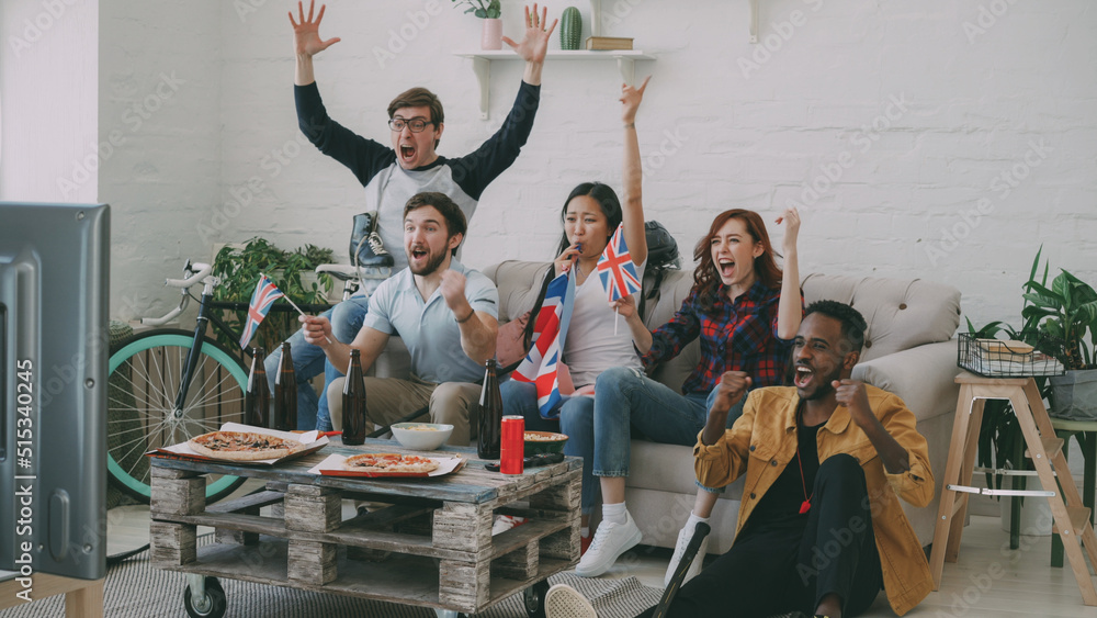 Multi ethnic group of friends sports fans with British national flags ...