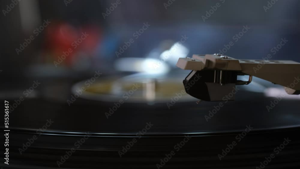 The Cartridge and stylus of Vinyl Record player playing on black vinyl ...
