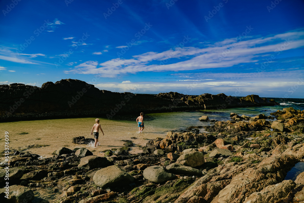 Children swimming at The Tanks tourist attraction natural rock pool at ...