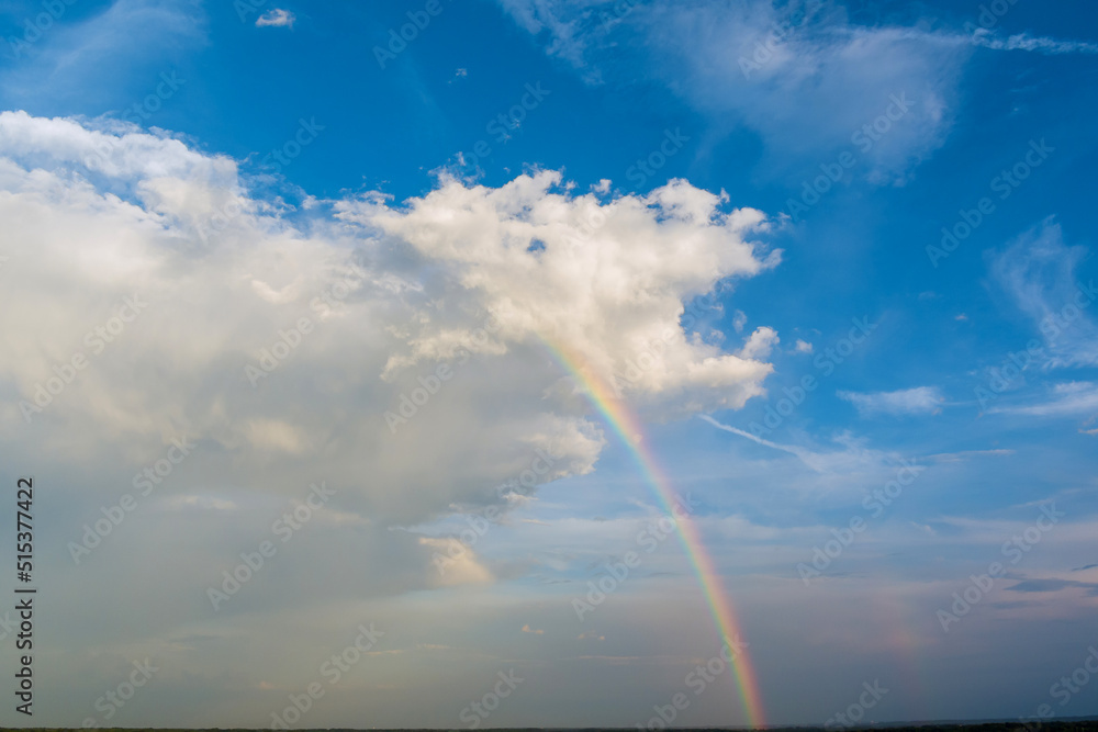 Magnificent panorama of a multicolored rainbow after rain with clouds ...