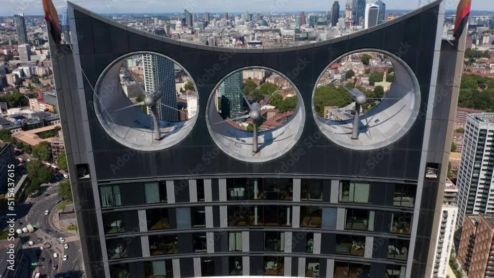 Ascending footage of top of Strata skyscraper with three big wind ...