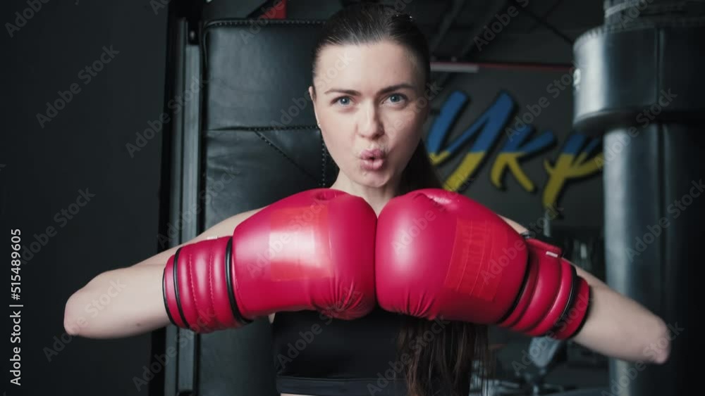 Woman fighter fist close-up - boxer hits the side of the video camera ...