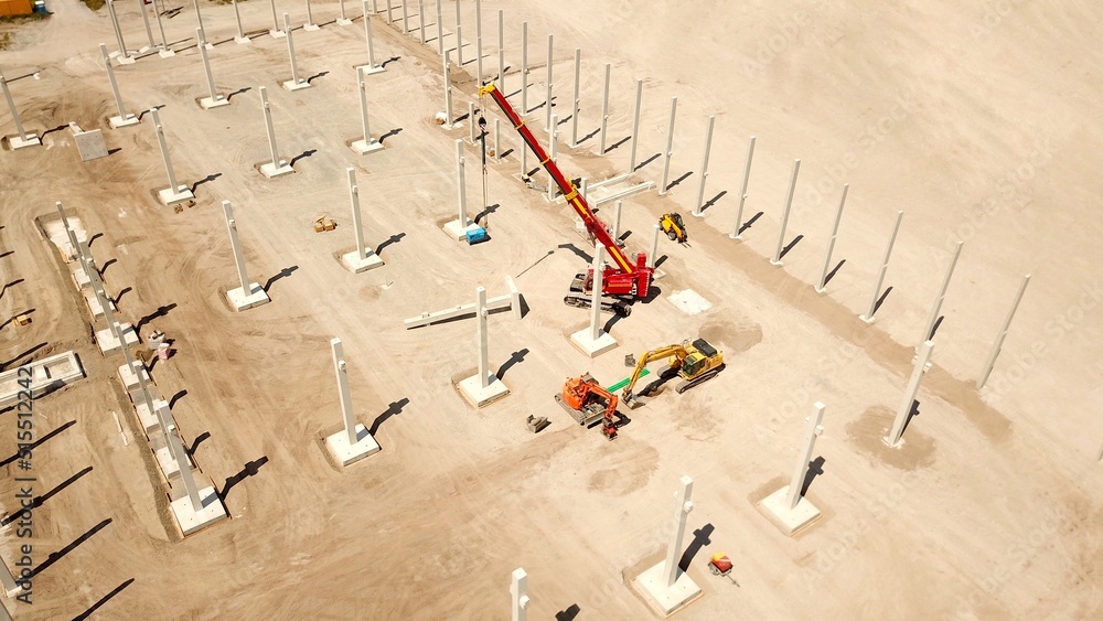 large construction site with precast concrete parts, excavators and a ...