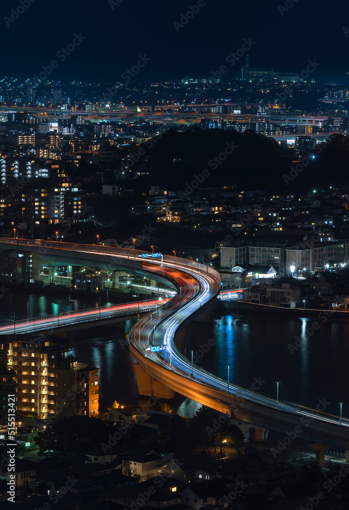 Bird's eye view at night of the illuminated urban expressway circular ...