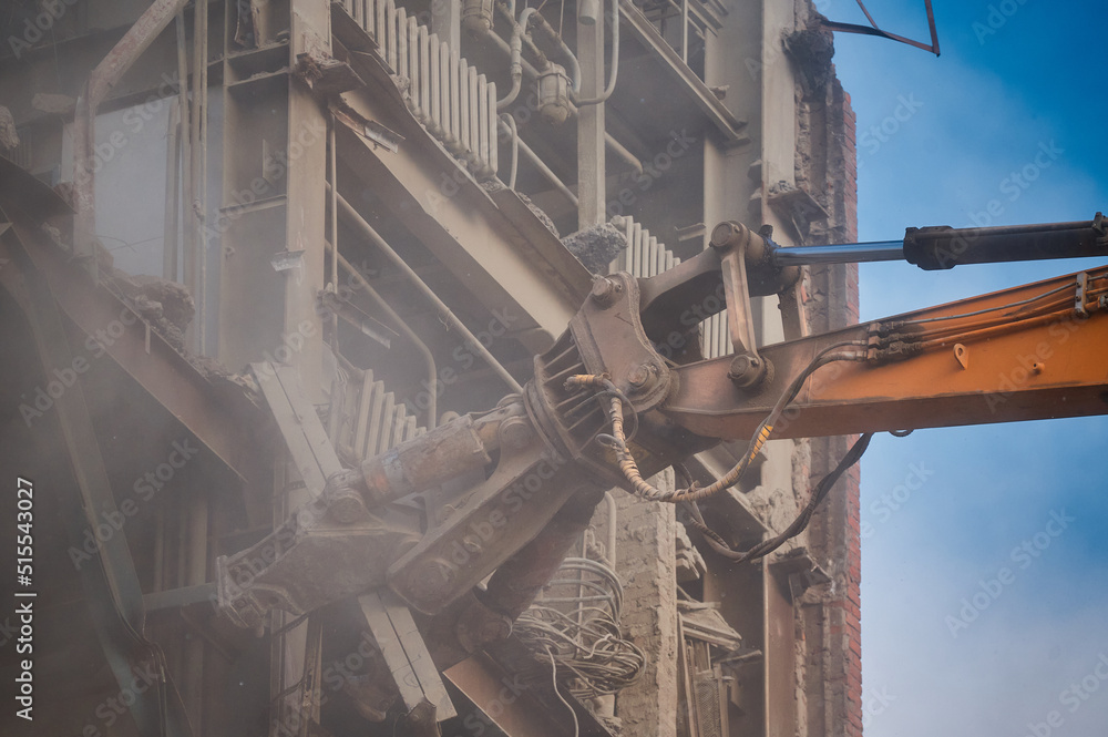 Hydraulic scissors on rig of crane cut building on site Stock Photo ...