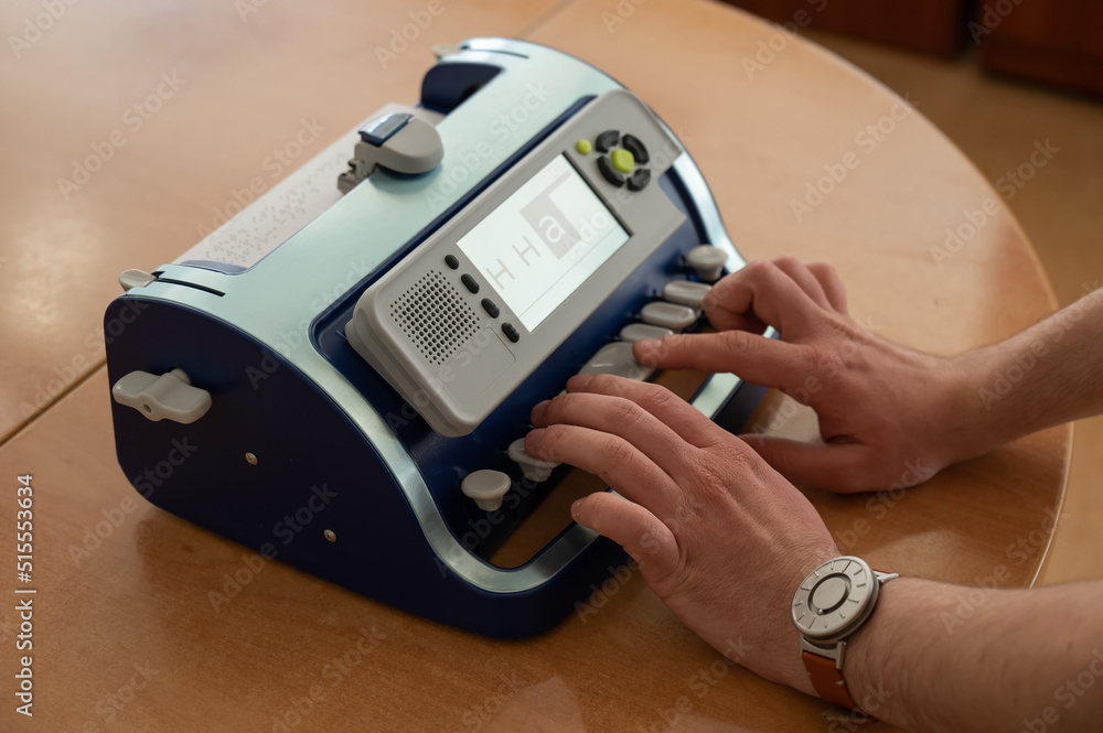 Blind man using braille typewriter. Stock Photo | Adobe Stock
