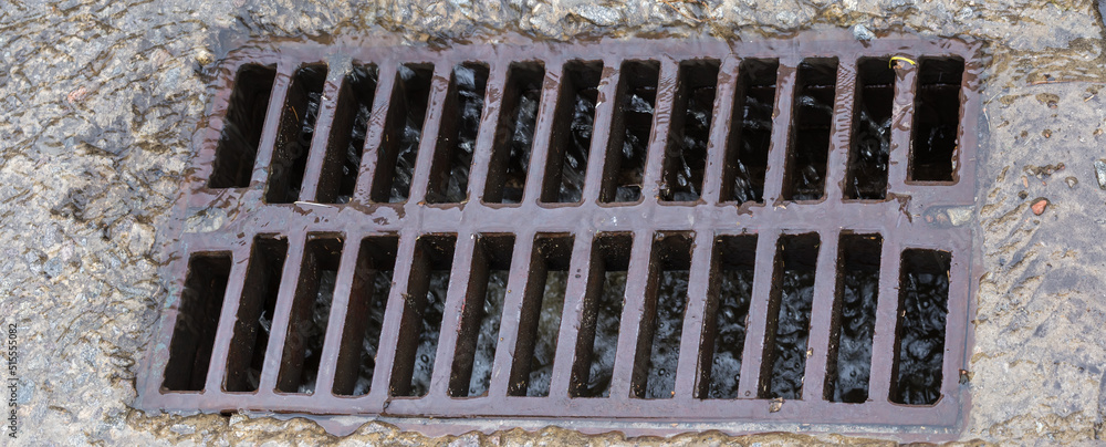 Cast iron grid of storm drain during rain close-up Stock Photo | Adobe ...