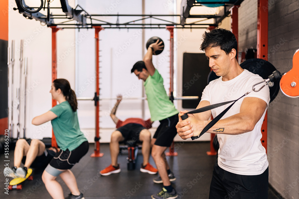 Group of beginners athletes exercising in a personal class with a ...