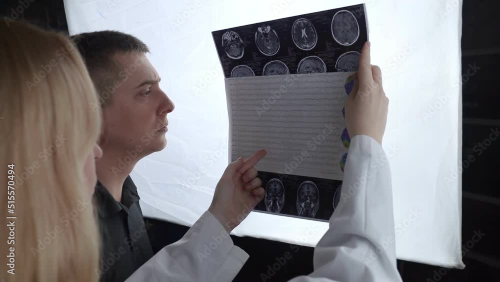 Epileptologist examines patient MRI and electroencephalogram. Concept ...