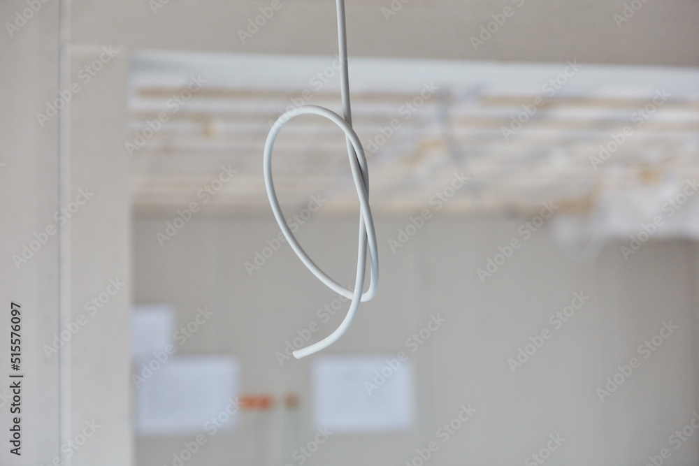 Cable with knots hangs from the ceiling during interior work Stock ...