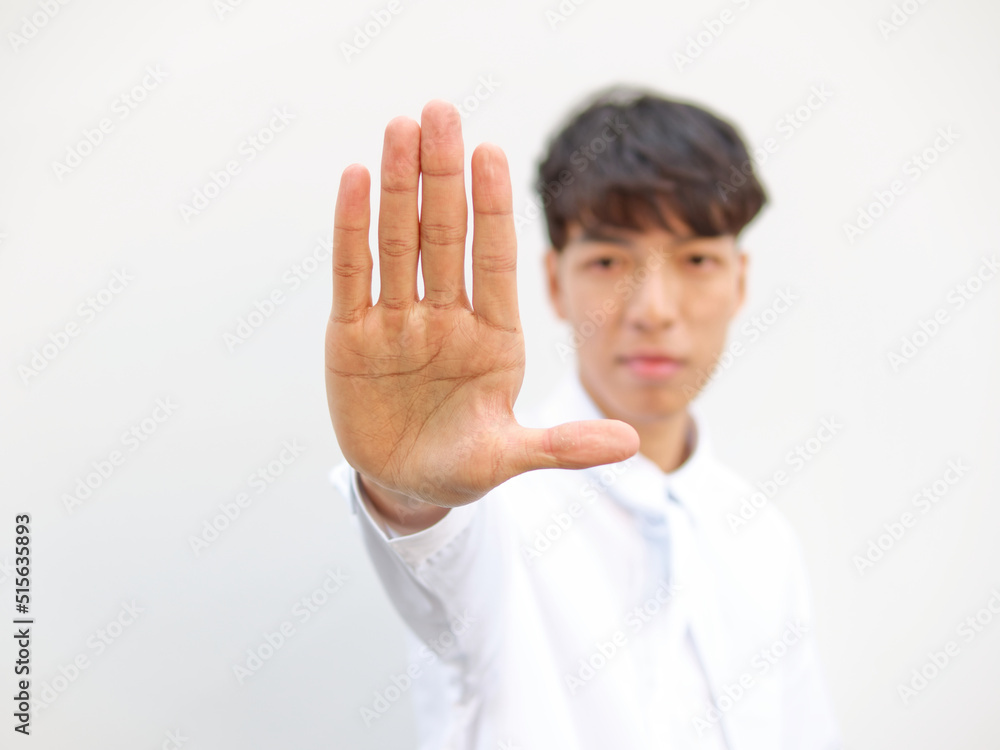 Portrait of Chinese young man with black hair in white shirt posing ...