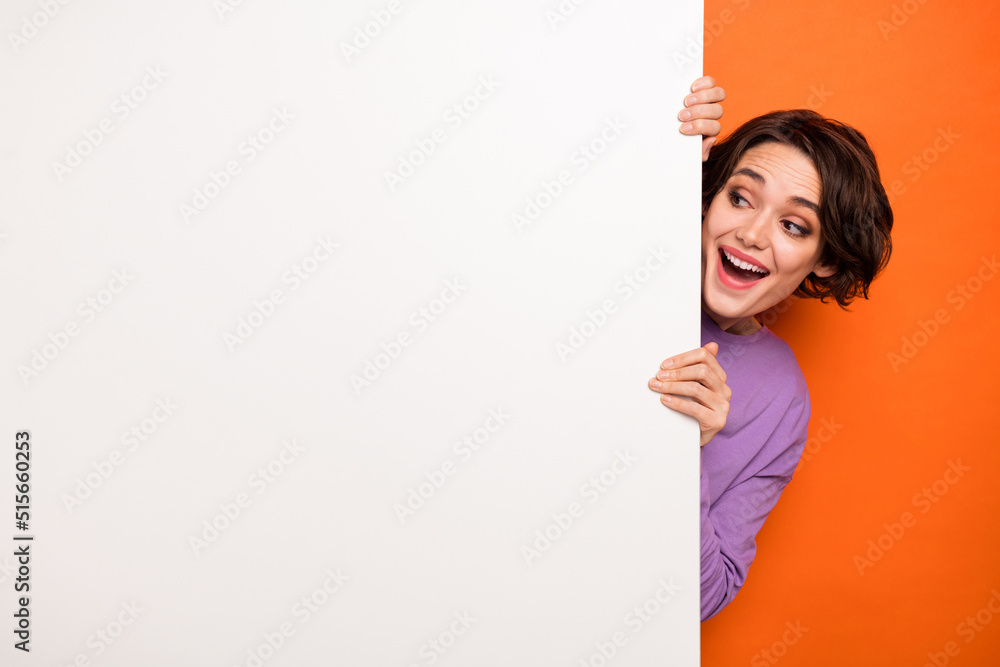 Photo of excited funky girl peeking look interested empty space blank ...