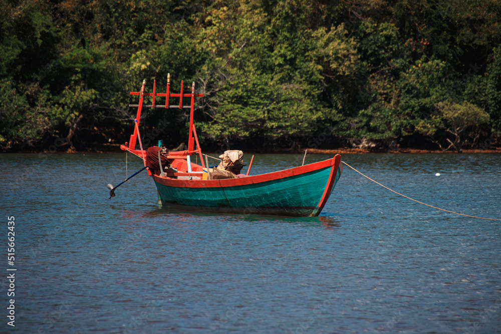 A traditional khmer fishing boat moored off the coast of Koh Tonsay or ...
