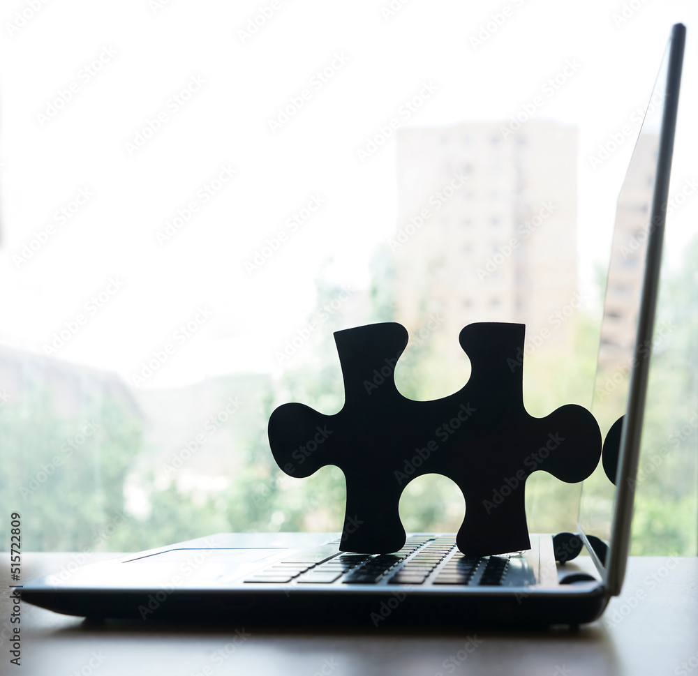 laptop with one piece of puzzle icon on window frame background. jigsaw ...
