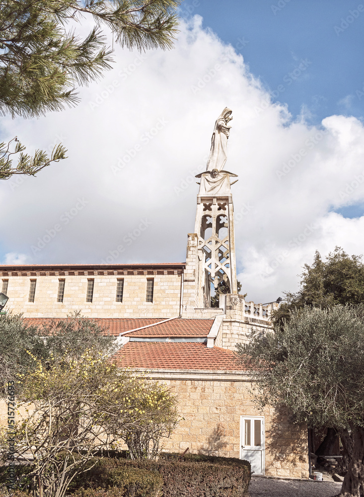 statue of Mary and Jesus sits atop the historic Catholic church and Ark ...
