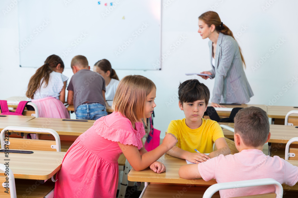 Interested preteen pupils divided into small groups, discussing ... Interested preteen pupils divided into small groups, discussing ...