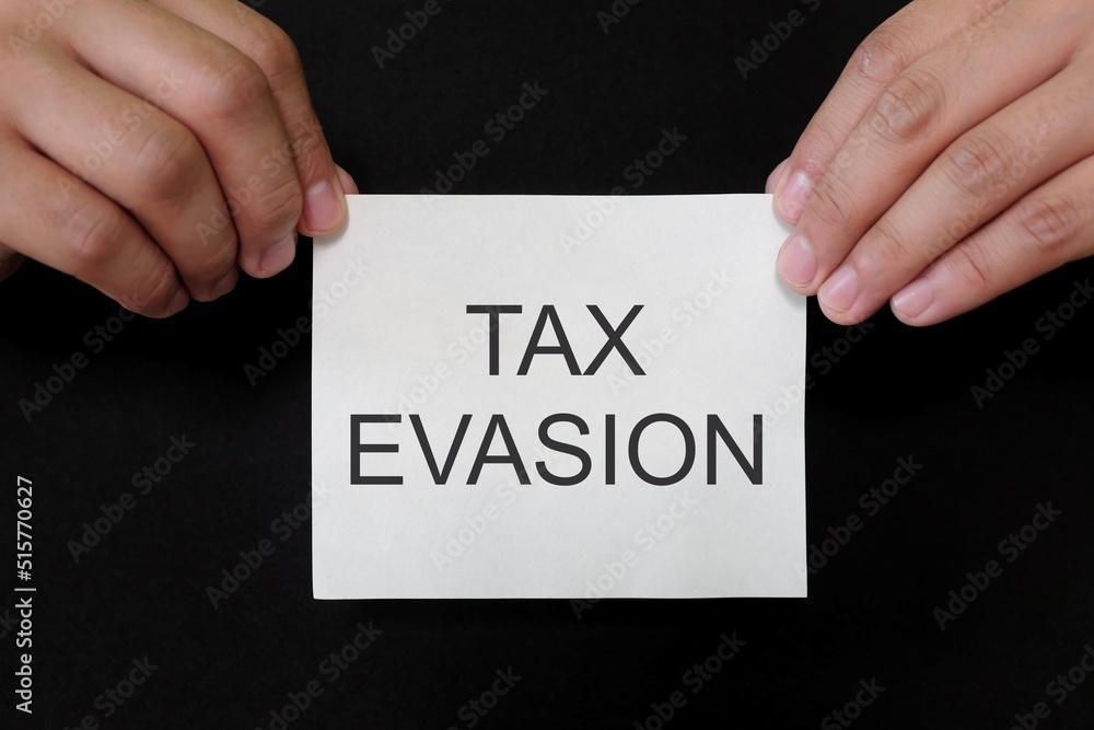 Tax evasion mug shot concept. Criminal hands holding paper placard with ...