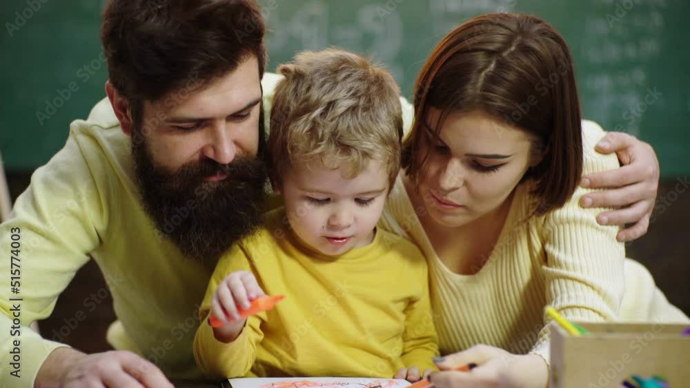Schoolboy and parents studying. Family with little child boy reading ...