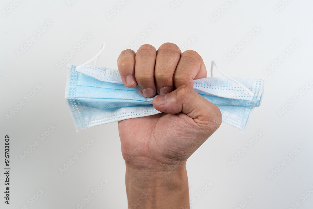 Hand grabbing the surgical mask with isolated white background. Mask ...