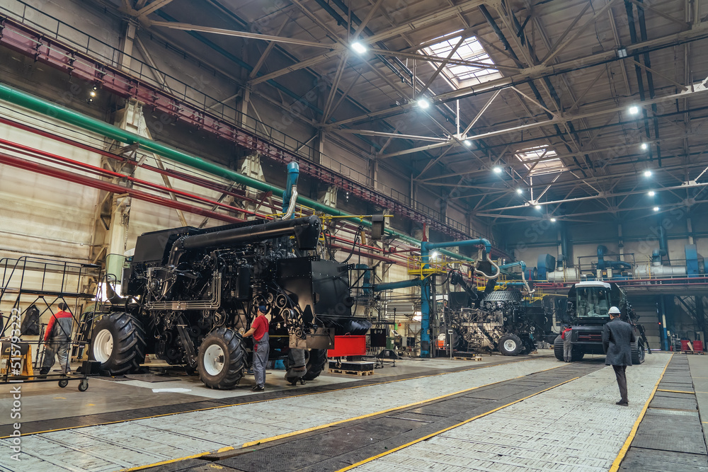 Factory hangar with combine harvesters assembled. Industrial production ...