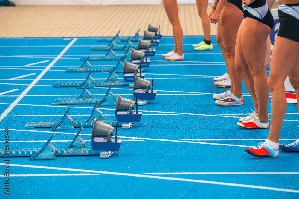 Track and field, running and sprinting. Legs of professional athletes ...